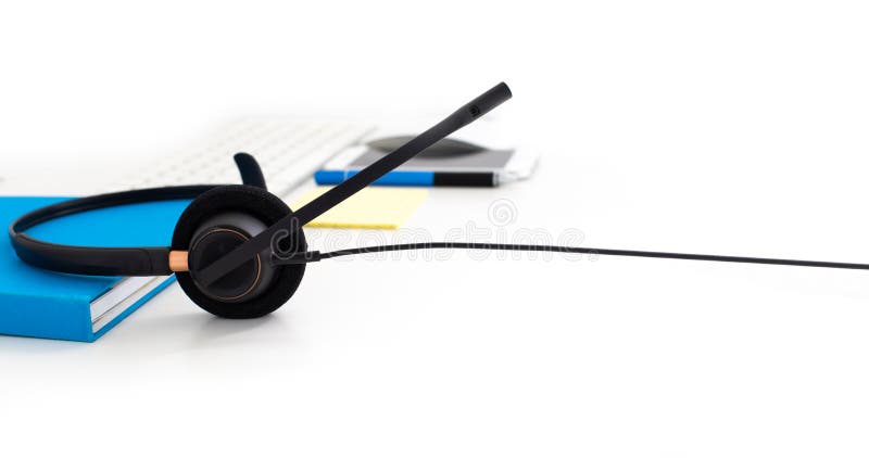 VOIP Headset, Pen and Notebook on Laptop Computer Keyboard ...