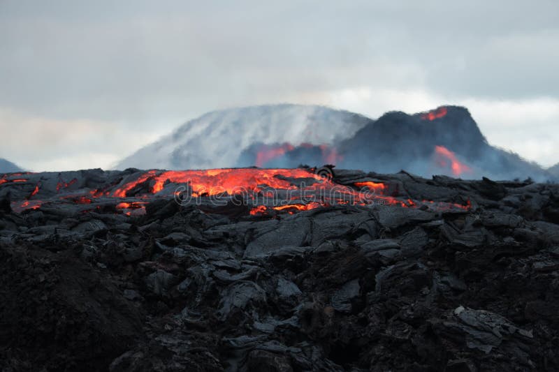 Volcanic Eruption with Glowing Orange Lava Flow Surrounded by a Pool of ...
