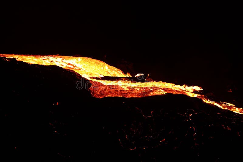 Volcanic Eruption with Glowing Orange Lava Flow Surrounded by a Pool of ...