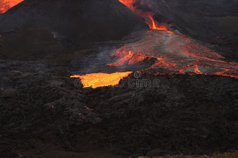 Volcanic Eruption with Glowing Orange Lava Flow Surrounded by a Pool of ...