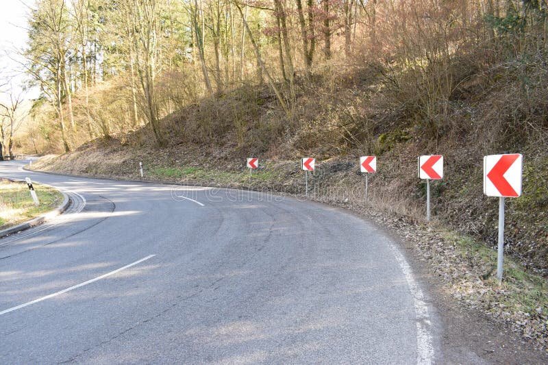 Serpentine Mountain Road Curve with White and Red Warning Signs Stock ...
