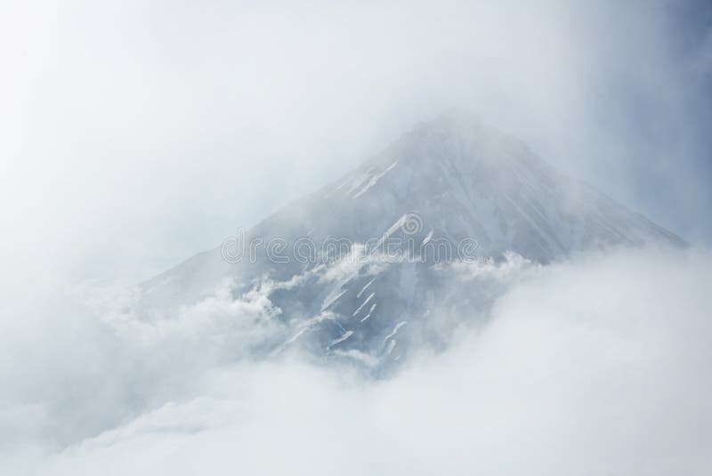 Volcano shrouded in fog stock image. Image of clouds - 122774687