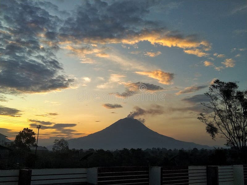 Volcano Sunset with Vibrant Clouds. Stock Image - Image of reflection ...