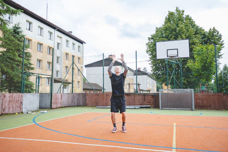 Volleyball Player Practicing Setting the Ball on a Hard Court, Focusing ...