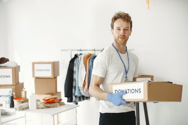 Volunteer Guy Packs Boxes with a Humanitarian Help Stock Photo - Image ...
