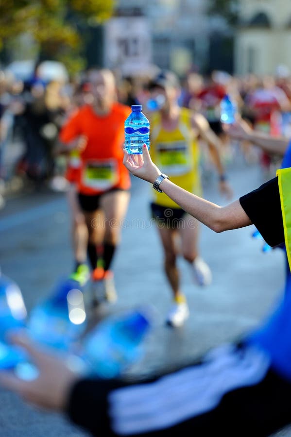 Volunteer Hand Offering a Small Bottle of Water at a Marathon ...