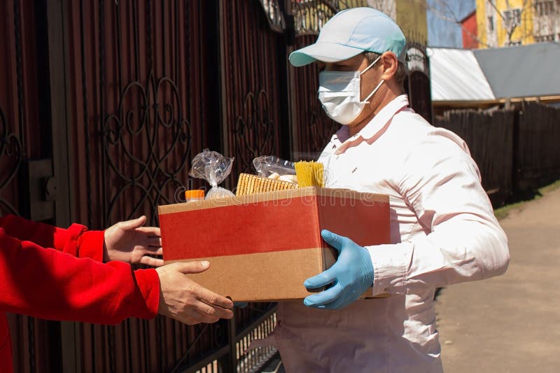 Volunteer Hands Over a Box of Food To those in Need Stock Image - Image ...