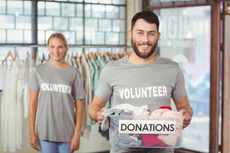 Volunteer Holding Clothes Donation Box in Office Stock Photo - Image of ...