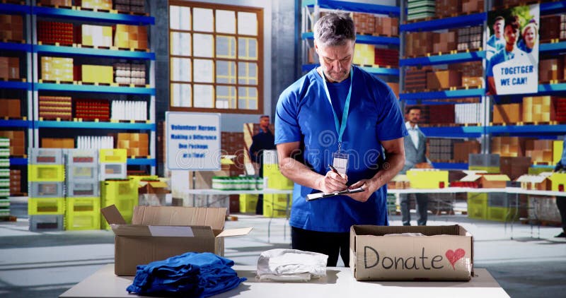 Volunteer Sorting Clothes stock image. Image of smiling - 306053761