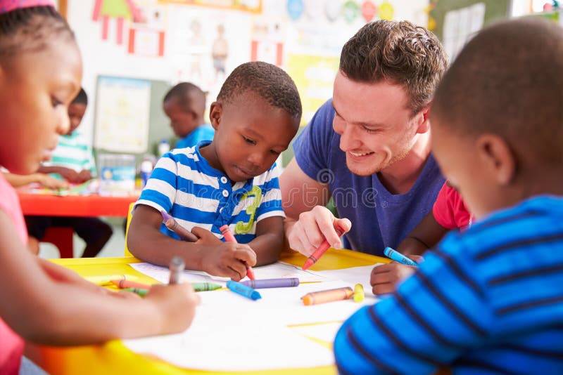Volunteer Teacher Sitting with Preschool Kids in a Classroom Stock ...