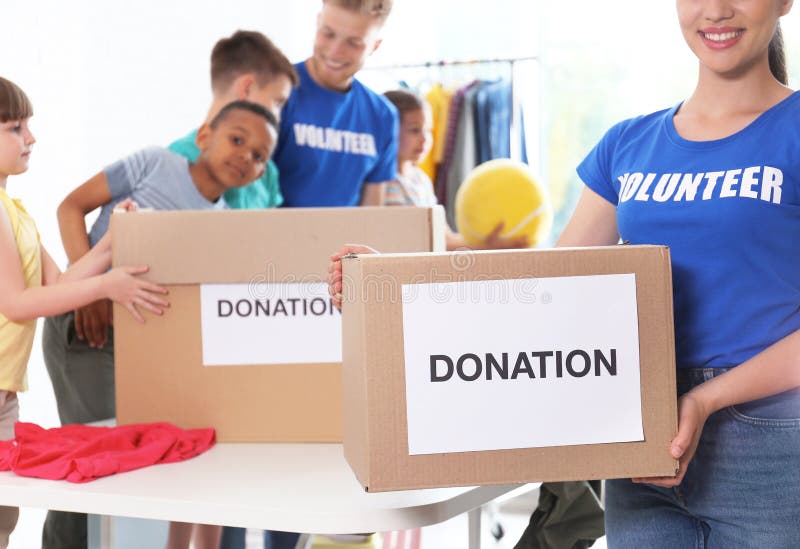 Volunteers with Children Sorting Donation Goods Stock Image - Image of ...
