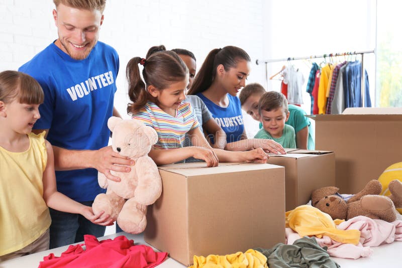 Volunteers with Children Sorting Donation Goods Stock Photo - Image of ...