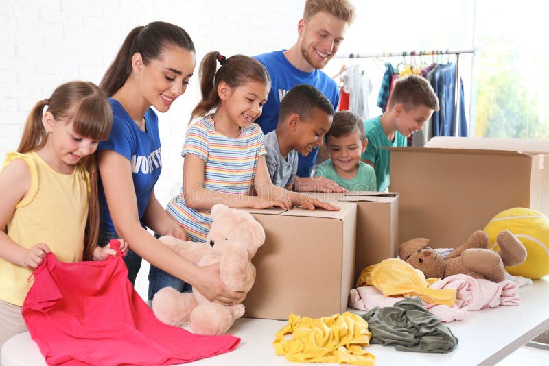 Volunteers with Children Sorting Donation Goods Stock Image - Image of ...