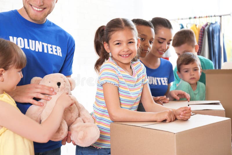 Volunteers with Children Sorting Donation Goods Stock Image - Image of ...