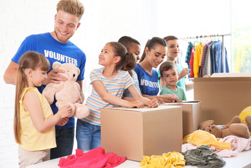 Volunteers with Children Sorting Donation Goods Stock Image - Image of ...