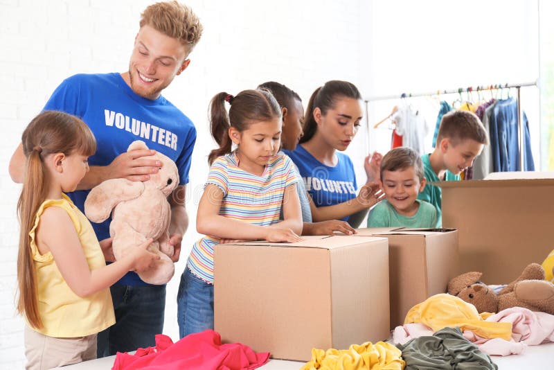 Volunteers with Children Sorting Donation Goods Stock Image - Image of ...
