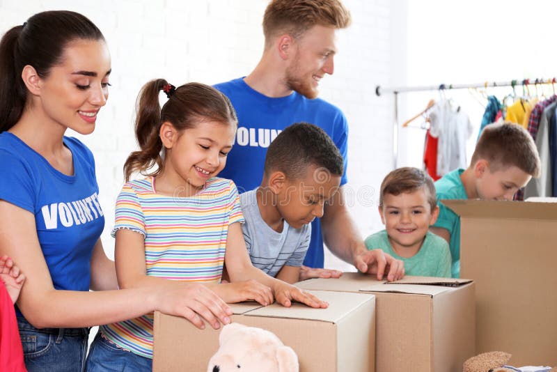 Volunteers with Children Sorting Goods Indoors Stock Image - Image of ...