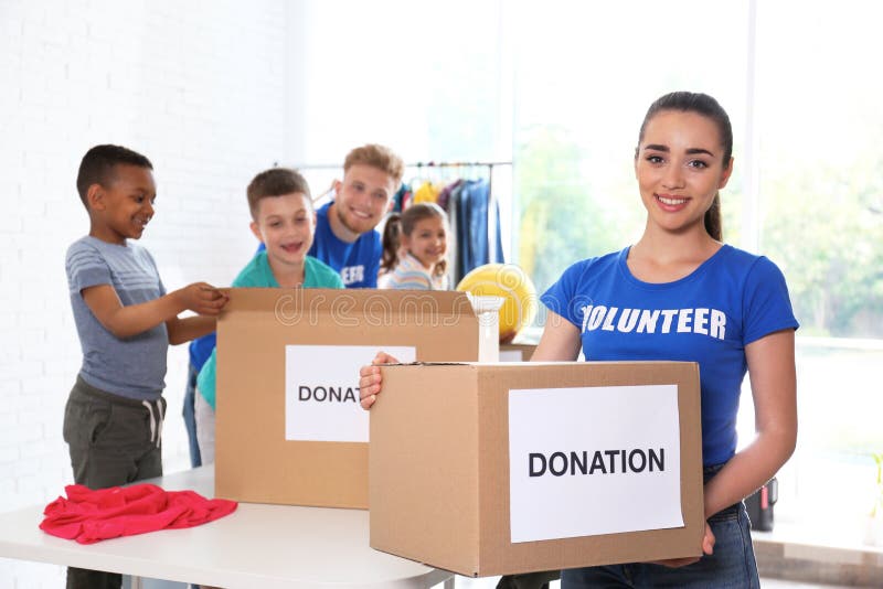 Volunteers with Children Sorting Donation Goods Stock Photo - Image of ...