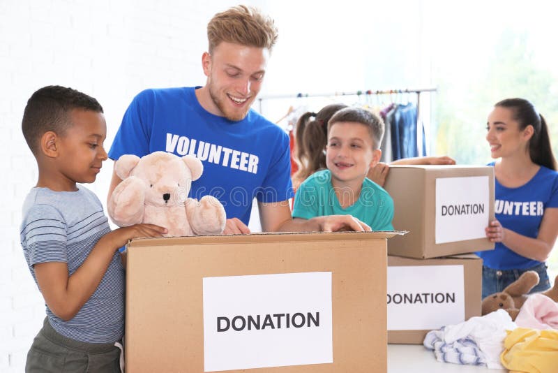 Volunteers with Children Sorting Donation Goods Stock Photo - Image of ...