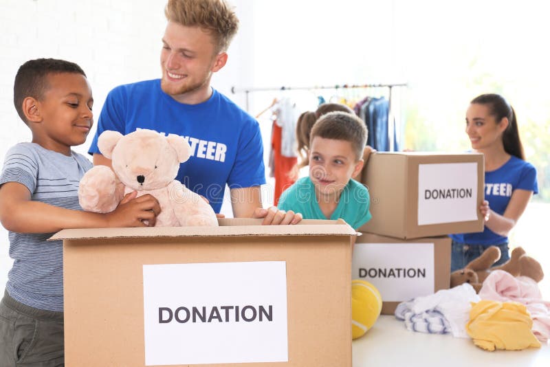 Volunteers with Children Sorting Donation Goods Stock Image - Image of ...
