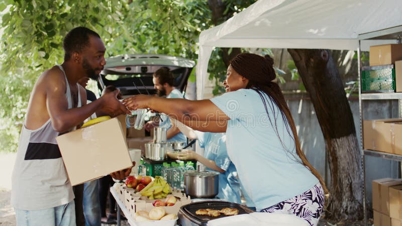 Volunteers Distributing Food Stock Footage - Video of holding, cheerful ...
