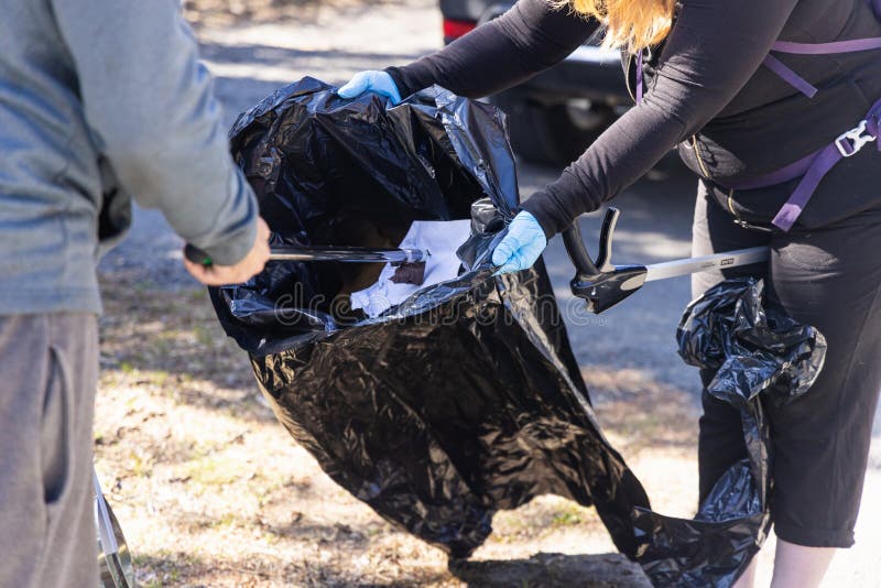 Volunteers Picking Up Trash Using Grabber Tool and Garbage Bag Stock ...