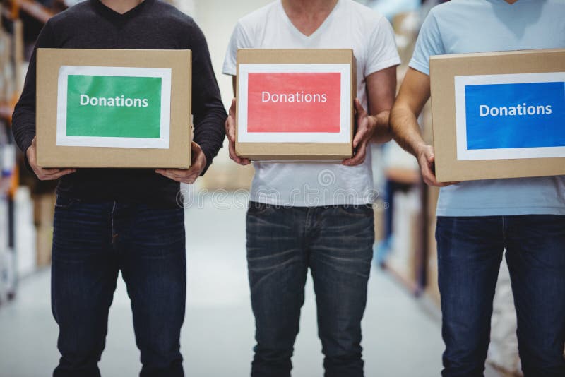 Volunteers Smiling at Camera Holding Donations Boxes Stock Image ...