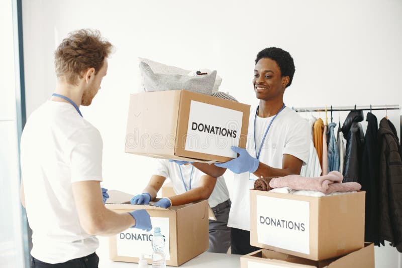 Volunteers Sort through Boxes with Help Stock Image - Image of ...