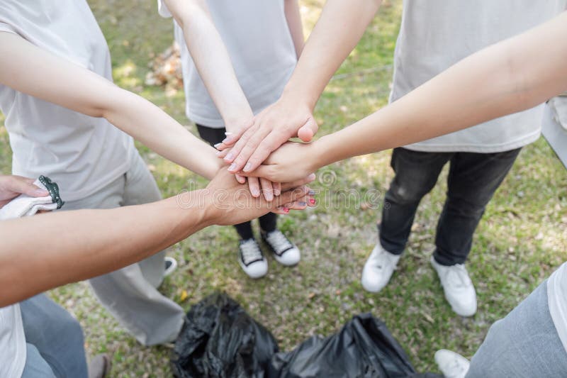 Teamwork in Action. Volunteers Joining Hands To Symbolize Unity in a ...