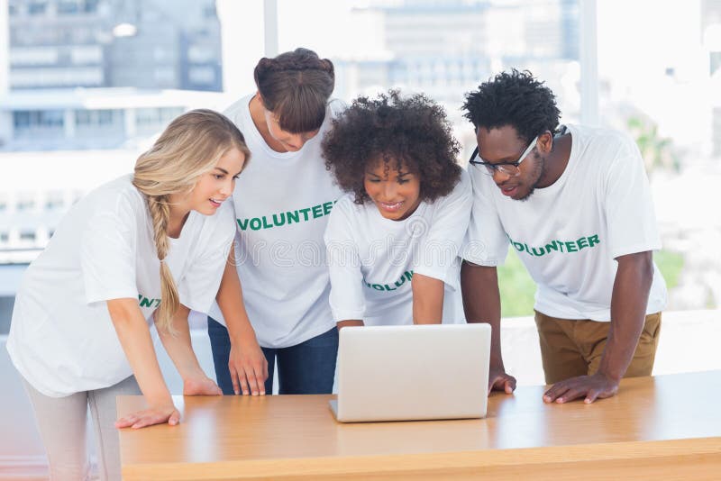 Volunteers Working Together on a Laptop Stock Photo - Image of moral ...