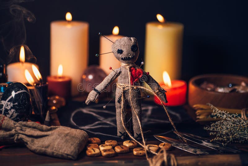Voodoo Doll on a Magic Table with Esoteric Objects and Burning Candles ...