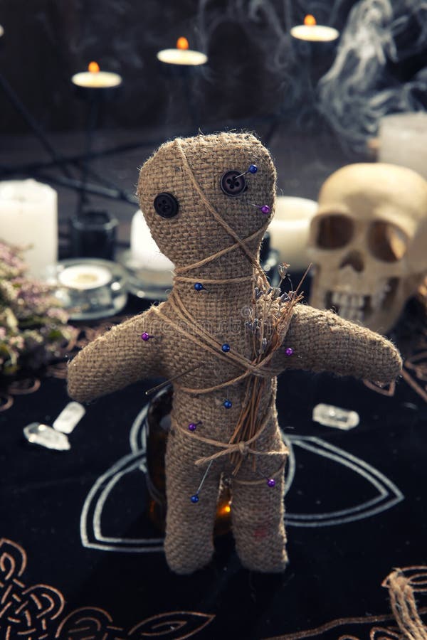 Voodoo Doll with Pins and Dried Flowers on Table Stock Photo - Image of ...