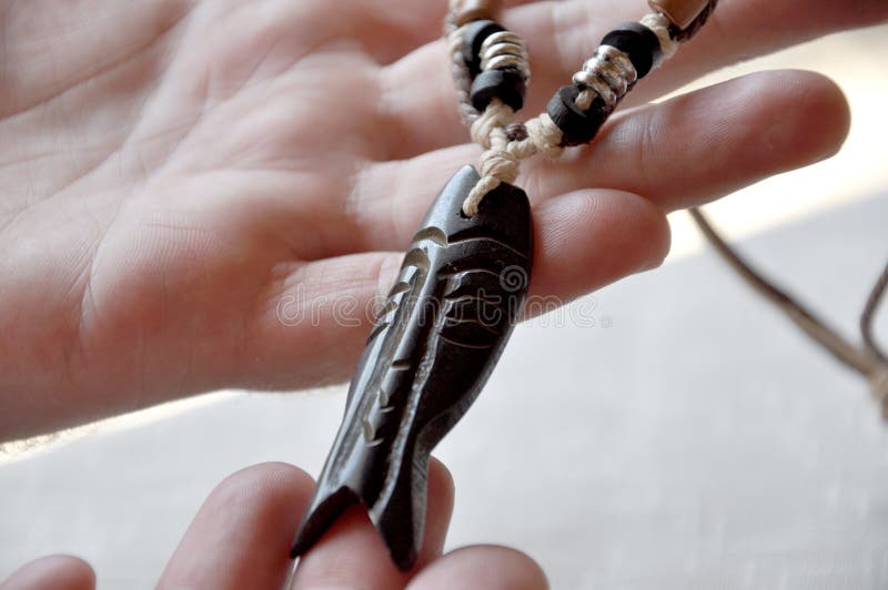 Voodoo pendant in hand stock image. Image of bead, pendant - 70404115
