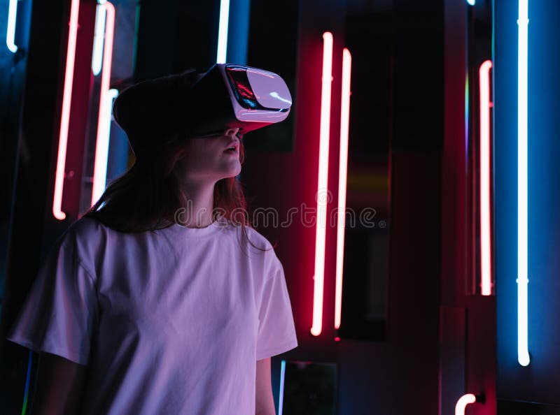 VR Experience. Young Woman in Neon Light in a Virtual Reality Headset ...