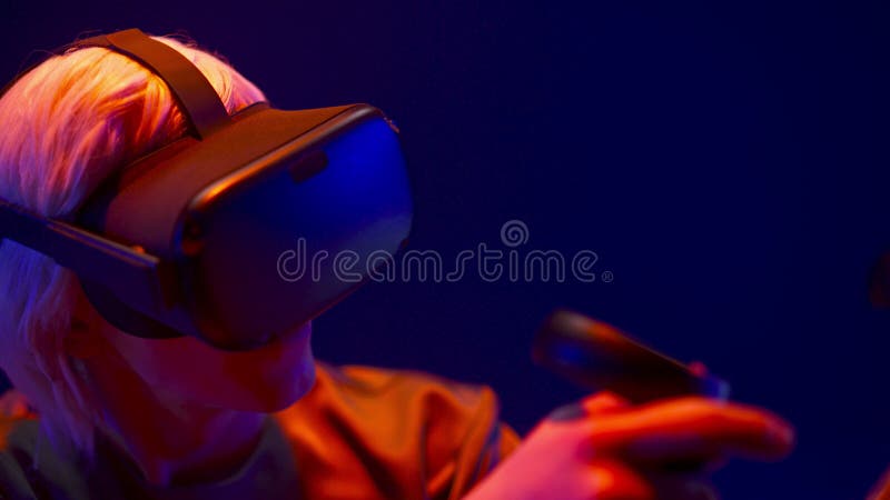 VR Headset Guy Playing in Neon Light. Man Using Futuristic Technology ...