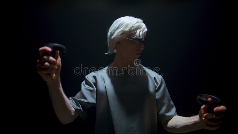 Vr Player Using Controllers in Dark Room. Focused Man Gesturing ...