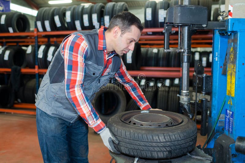 Vulcanizing Shop Worker Removing Tire from Rim Stock Image - Image of ...