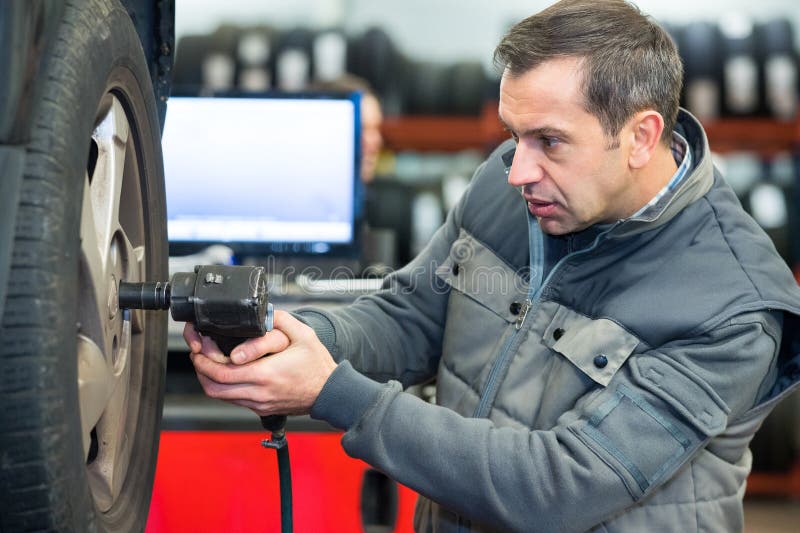 Vulcanizing Shop Worker Removing Tire Stock Photo - Image of ...