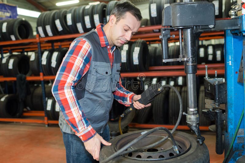 Vulcanizing Worker Removing Rim Using Tire Clamp Stock Photo - Image of ...