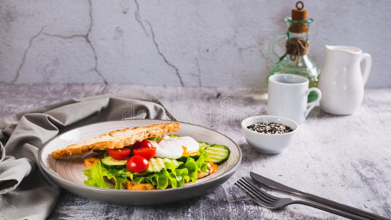 Waffle Bread Sandwich with Poached Egg and Vegetables on a Plate on the ...