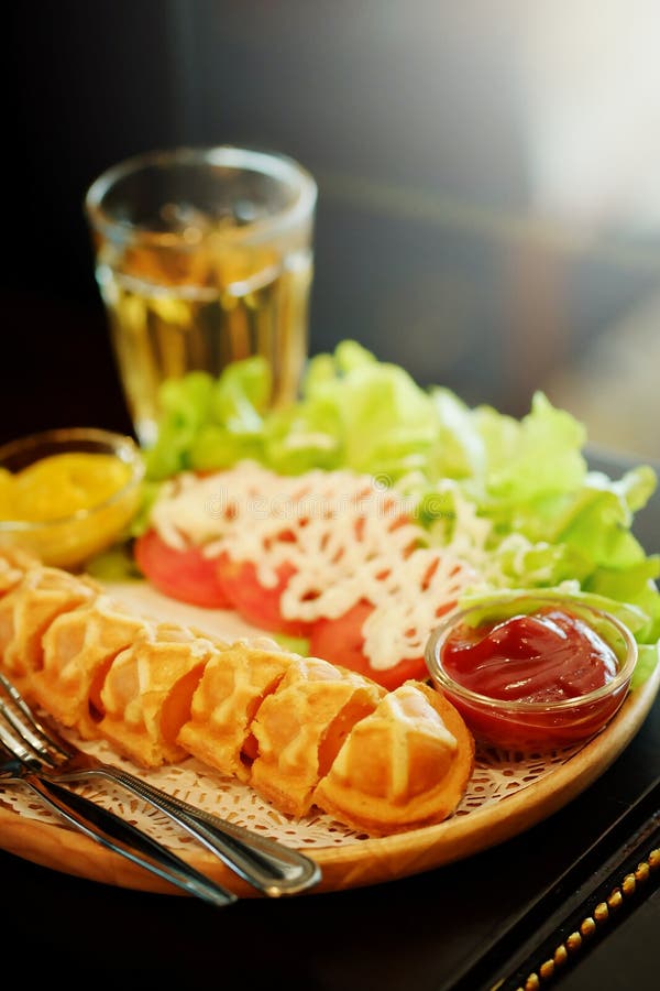 Waffle Hot Dog Stick Set with Salad and Hot Tea on Table Stock Image ...
