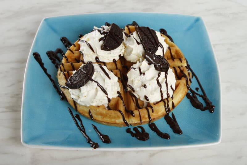 Waffles With Chocolate Cookie Sandwich Chocolate Syrup And Whipped
