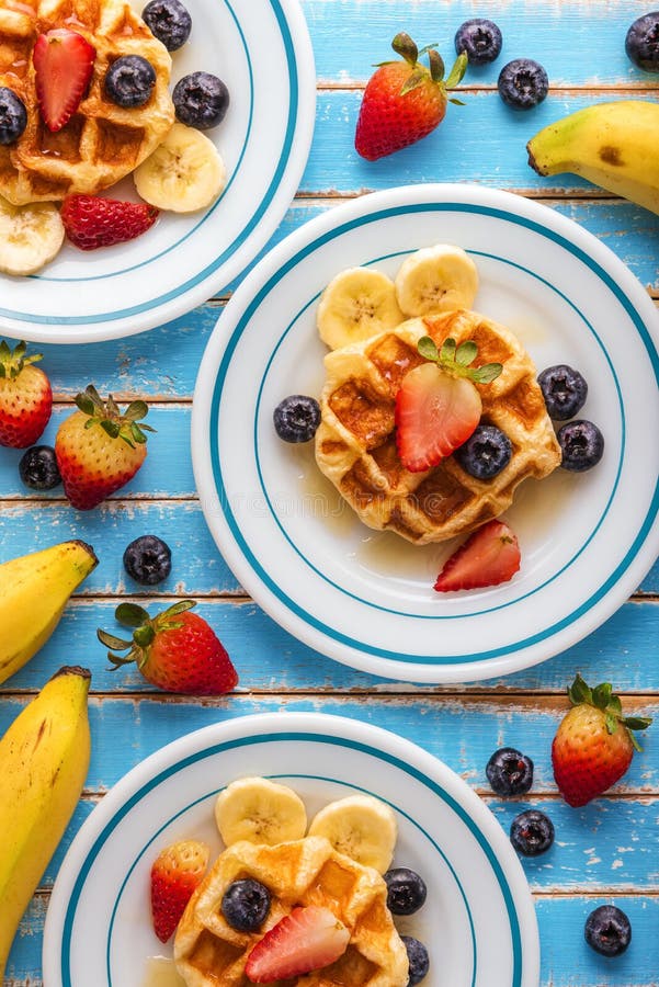 Waffles with Fresh Fruit and Caramel on Blue Table Stock Photo - Image ...