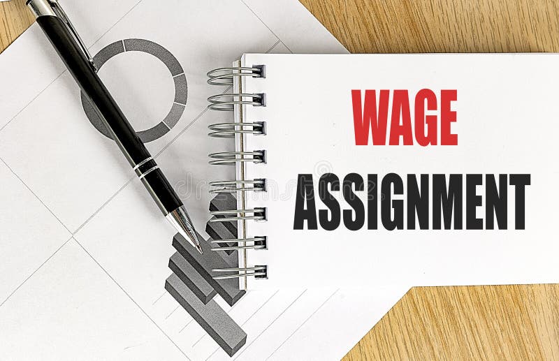 WAGE ASSIGNMENT Text on Notebook with Chart on Wooden Background Stock ...