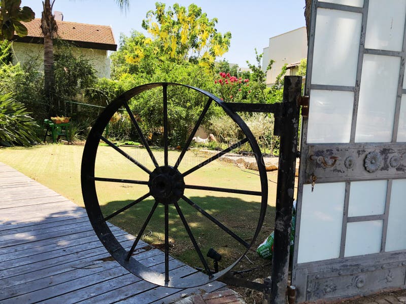 Wagon Wheel Gate on the Background of Green Trees Stock Photo - Image ...