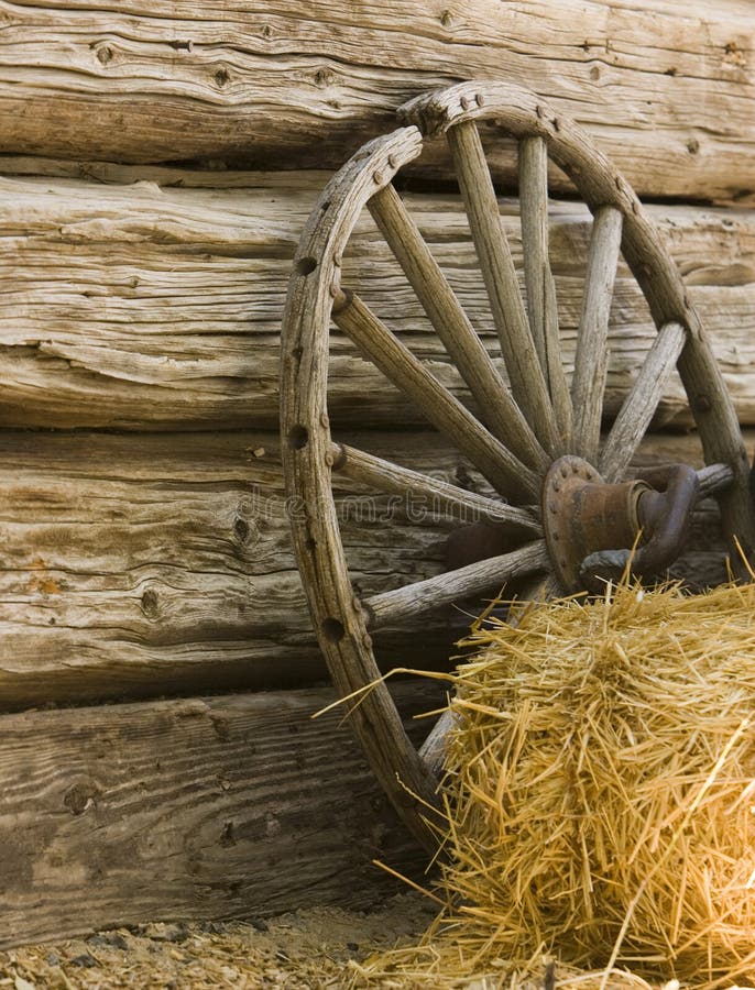 Wagon Wheel and Hay Bale stock image. Image of building - 7930401