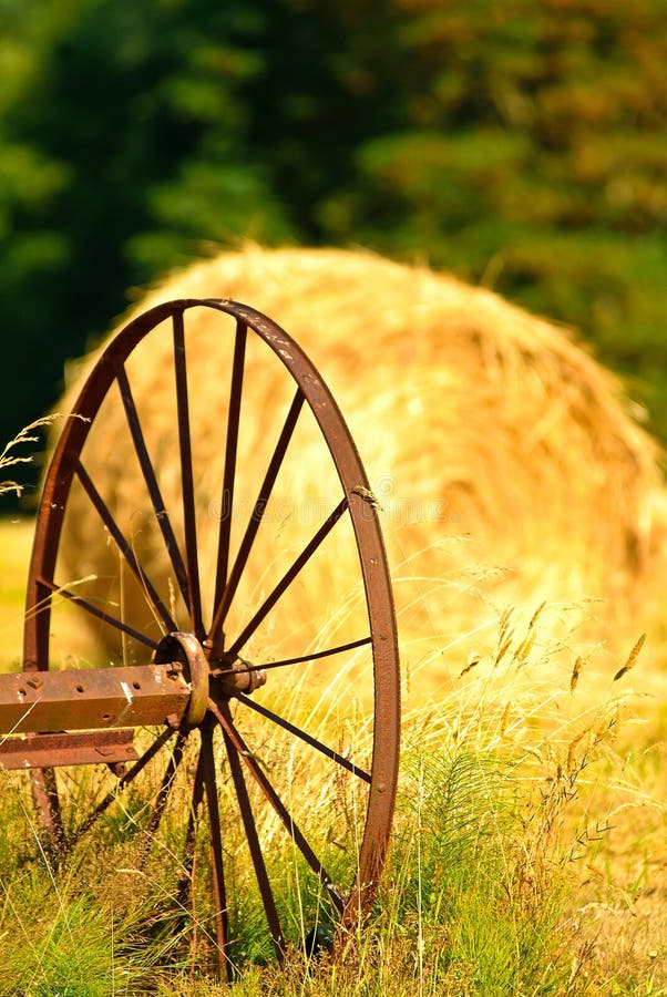 Wagon wheel and Hay stock photo. Image of steel, roll - 57884518