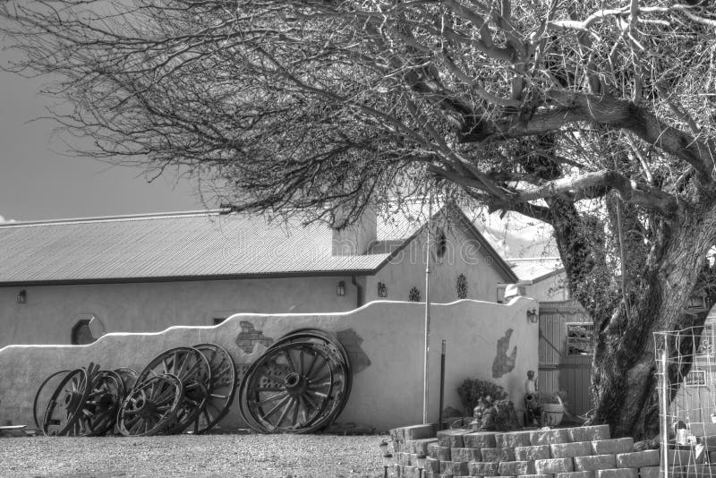 Wagon Wheels Along Wall in Southwestern Town Stock Photo - Image of ...