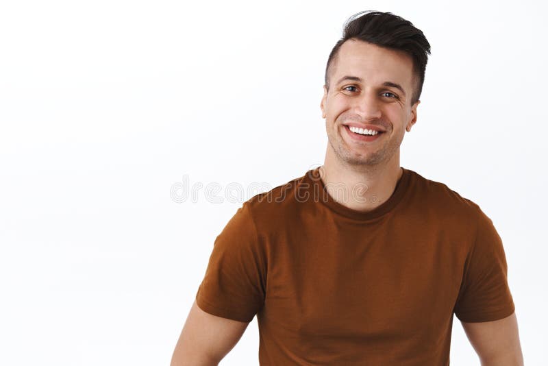 Waist Up Portrait Of Handsome Friendly Looking Kind Man Smiling At