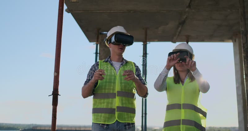 Waist Up Portrait of Two Modern Construction Workers Using VR Gear To ...
